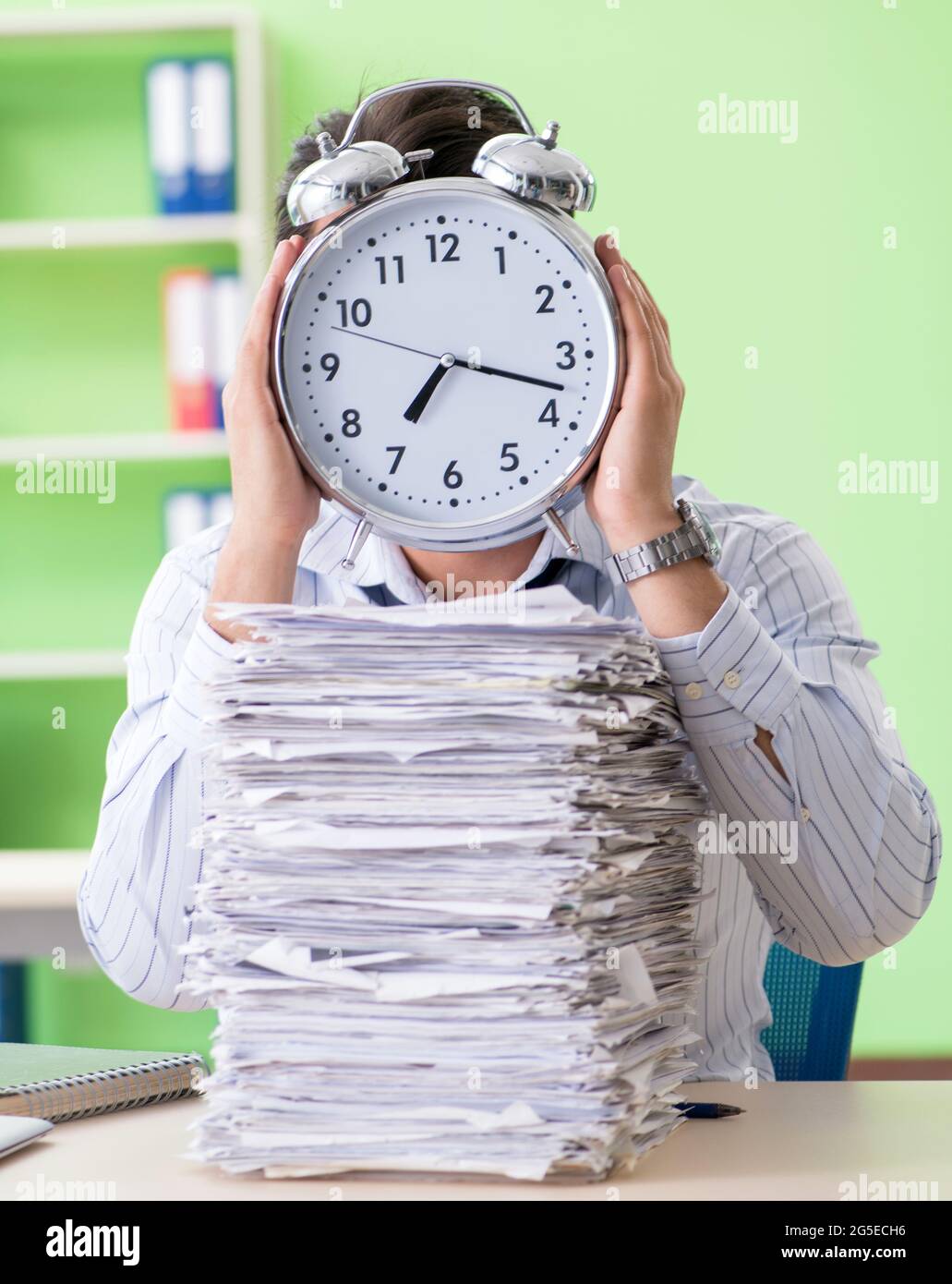 The businessman having problems with paperwork and workload Stock Photo ...