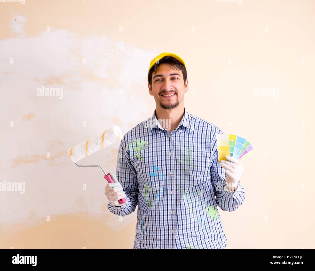 The painter man painting the wall at home Stock Photo - Alamy