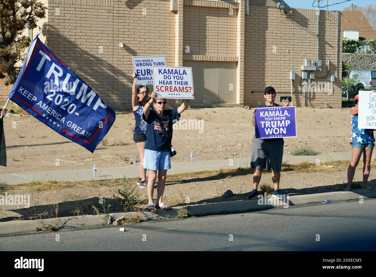 People protest on the side of the road as U.S. Vice President Kamala ...