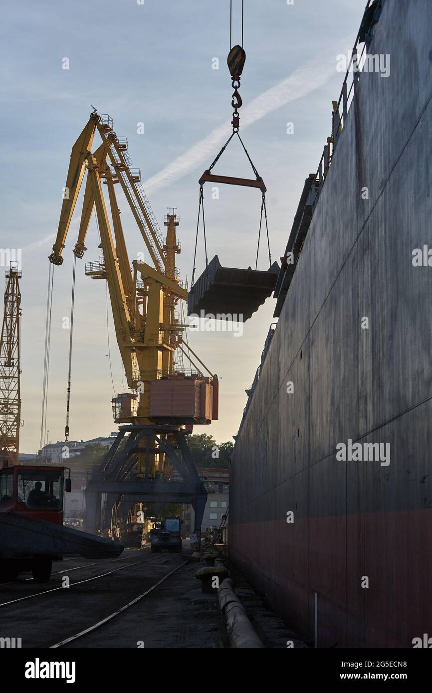Loading cast iron ingots on ship bulk. Loading metal on ship ...