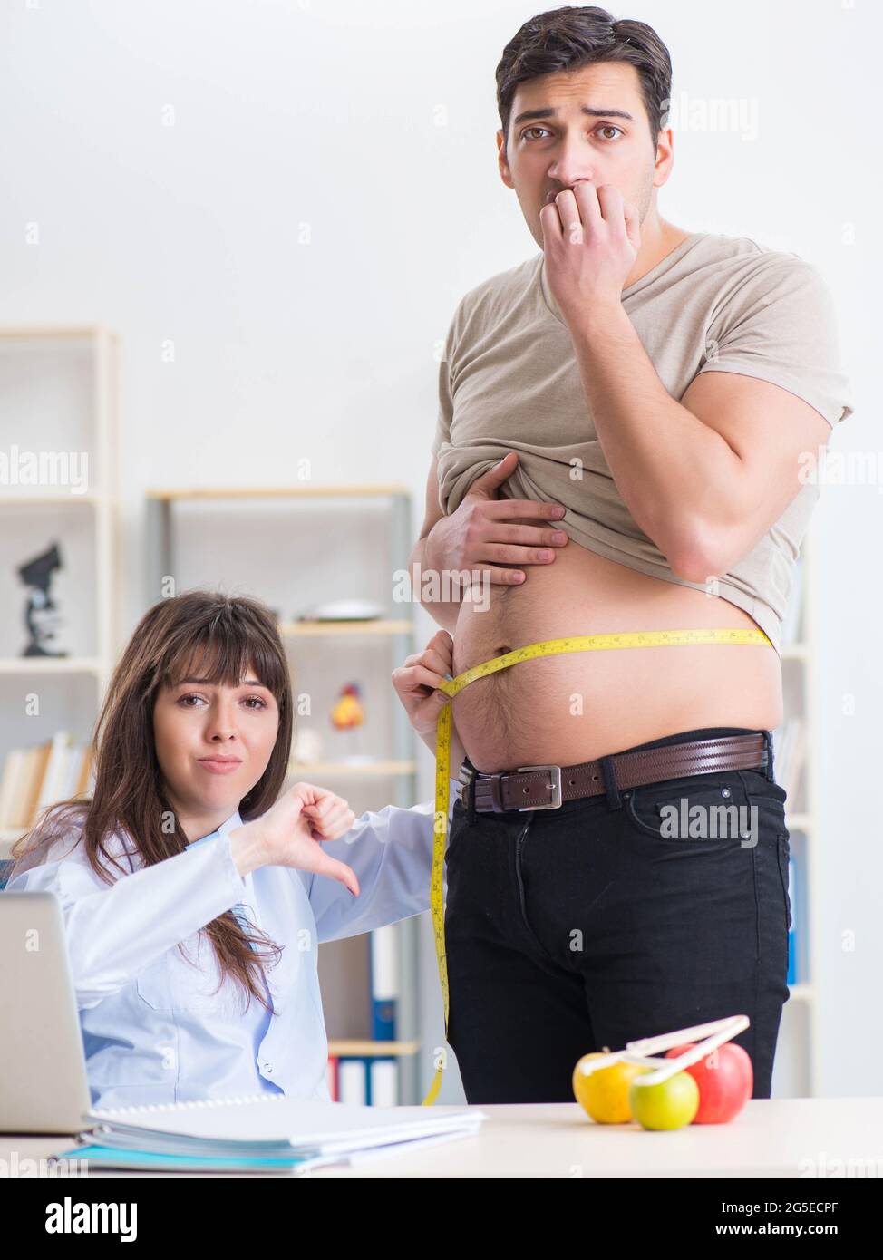 The doctor dietician giving advices to fat overweight patient Stock ...