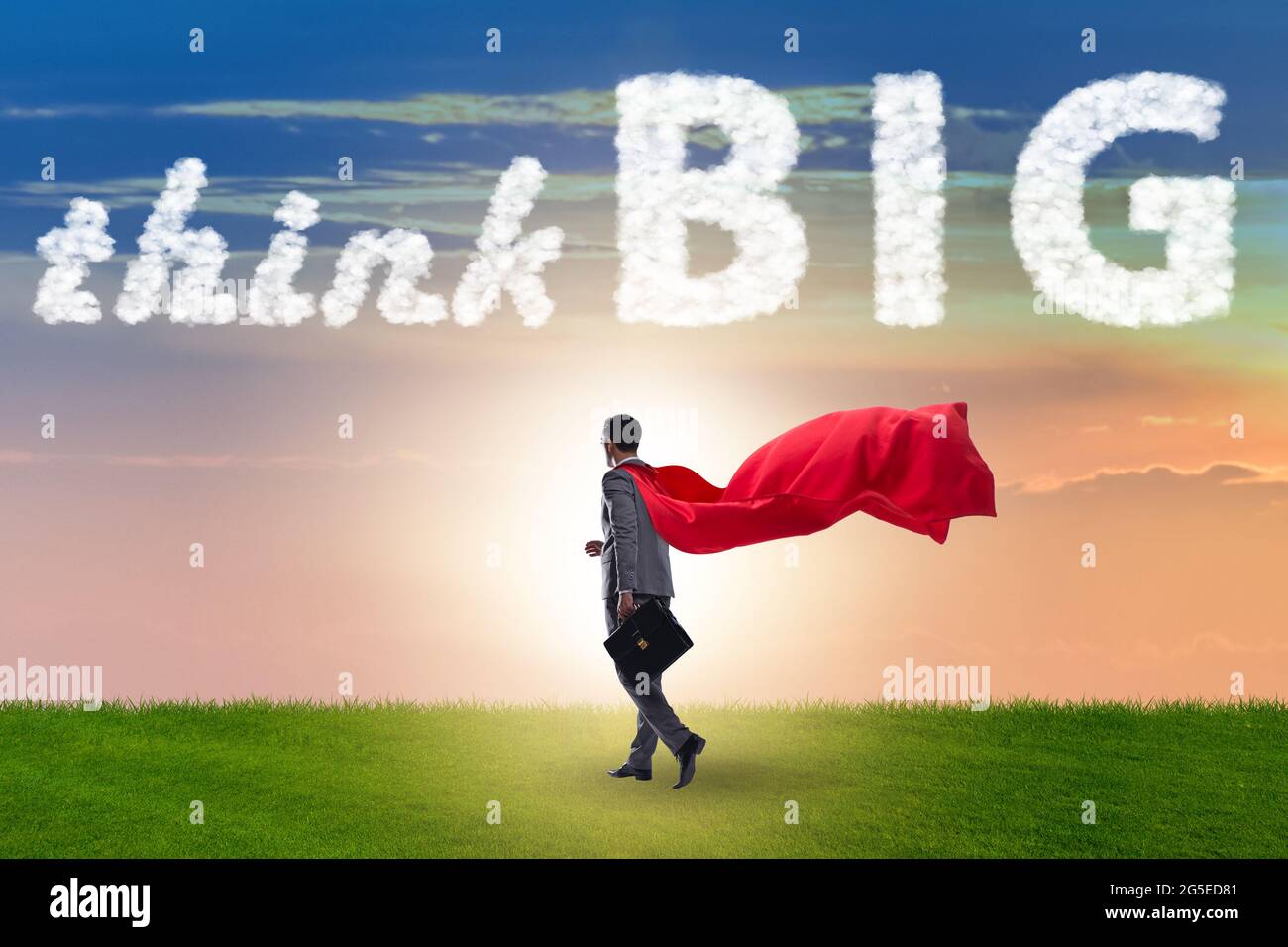 Think big concept with the businessman superhero Stock Photo - Alamy