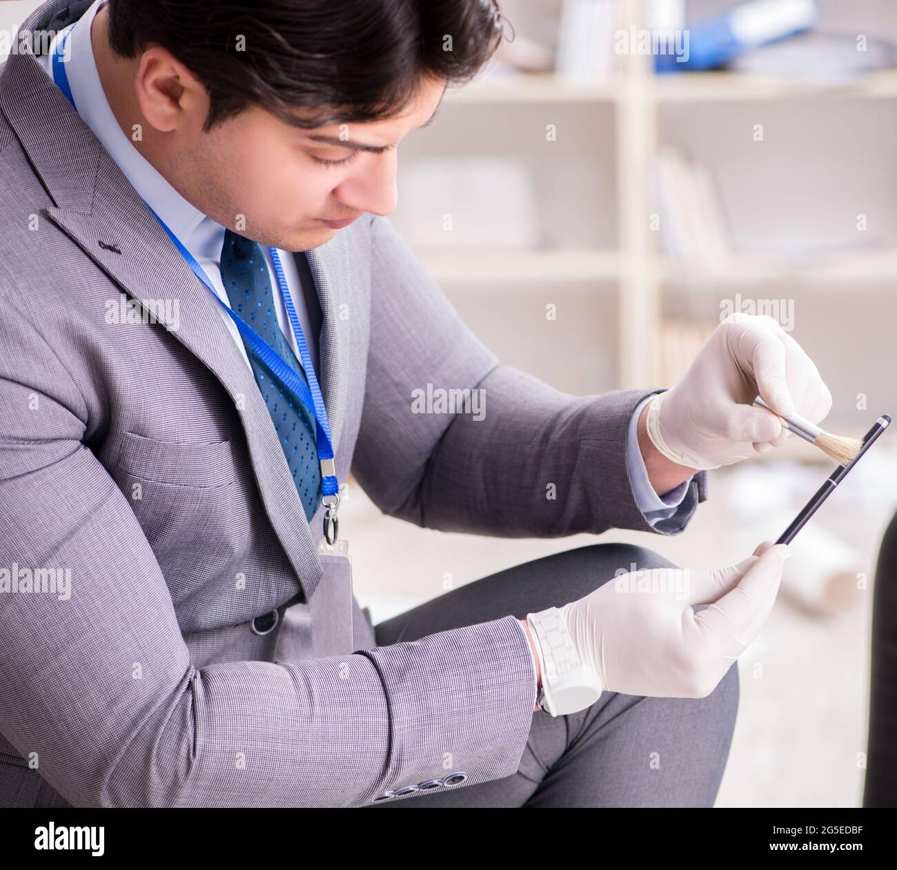 The young man during crime investigation in office Stock Photo - Alamy