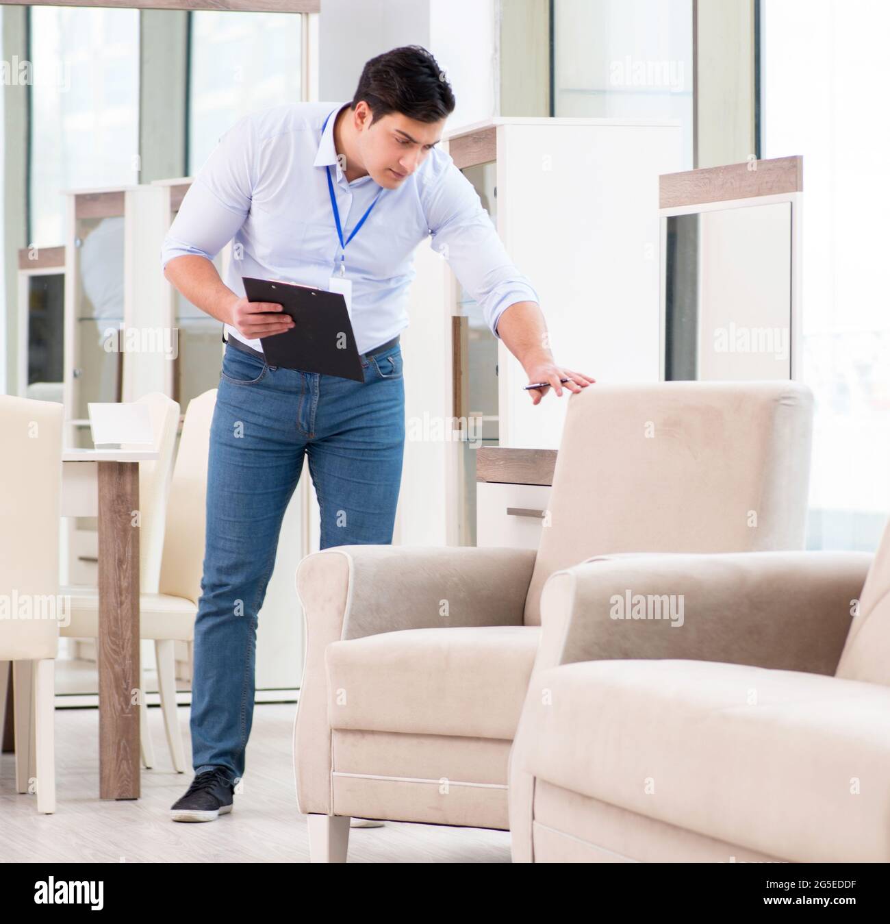 The sales assistant in furniture store Stock Photo - Alamy
