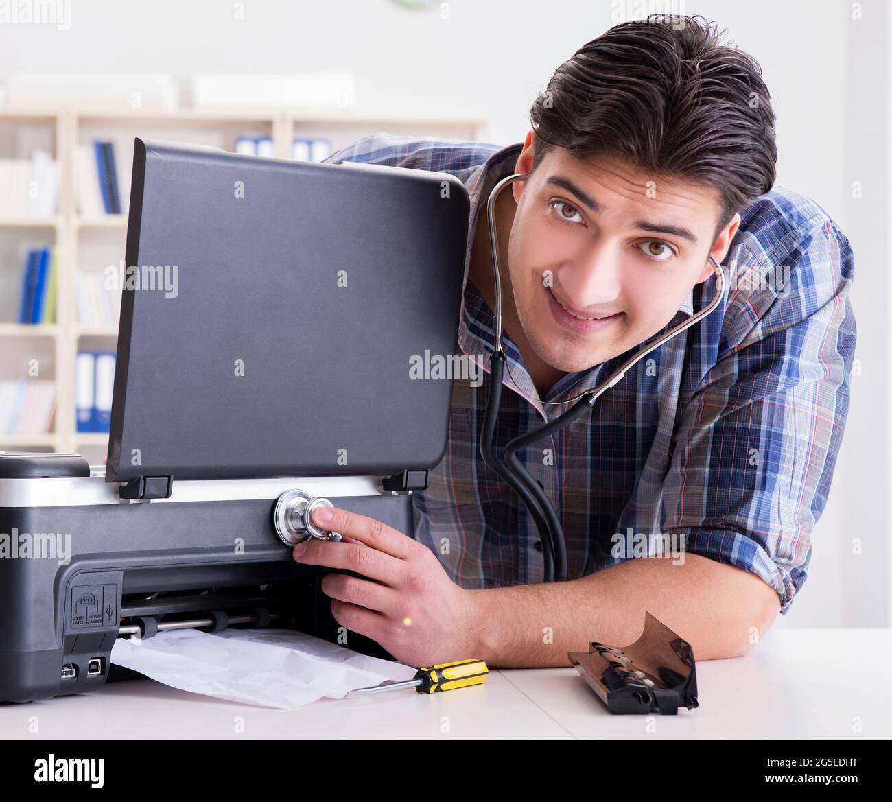 The repairman repairing broken color printer Stock Photo - Alamy