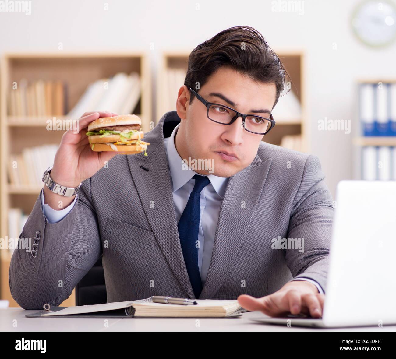 Hungry funny businessman eating junk hi-res stock photography and ...