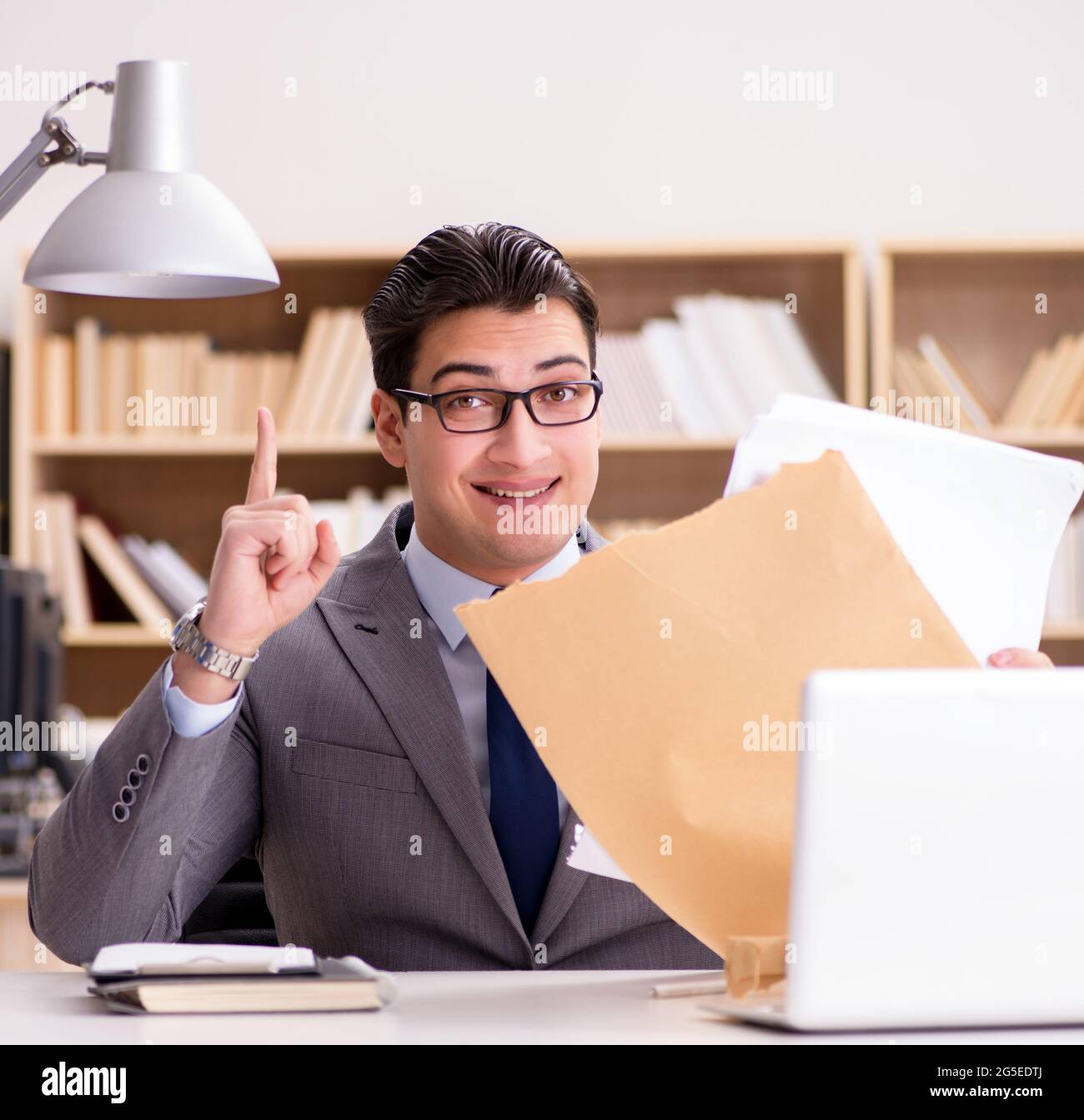 The businessman receiving letter in the office Stock Photo - Alamy