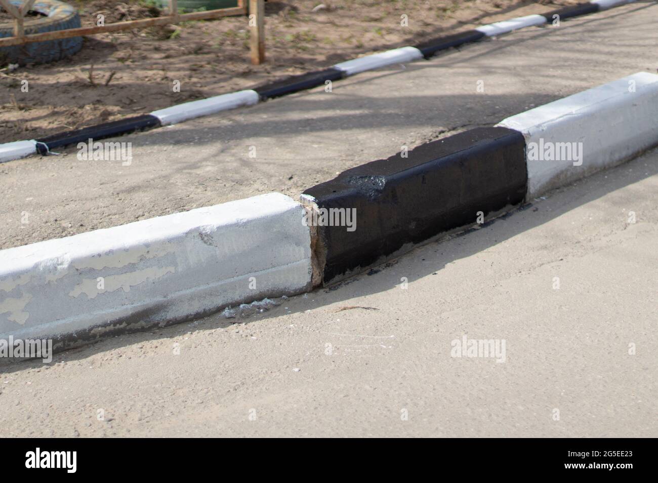 Marked border. Black and white painted road curb. Road markings for ...