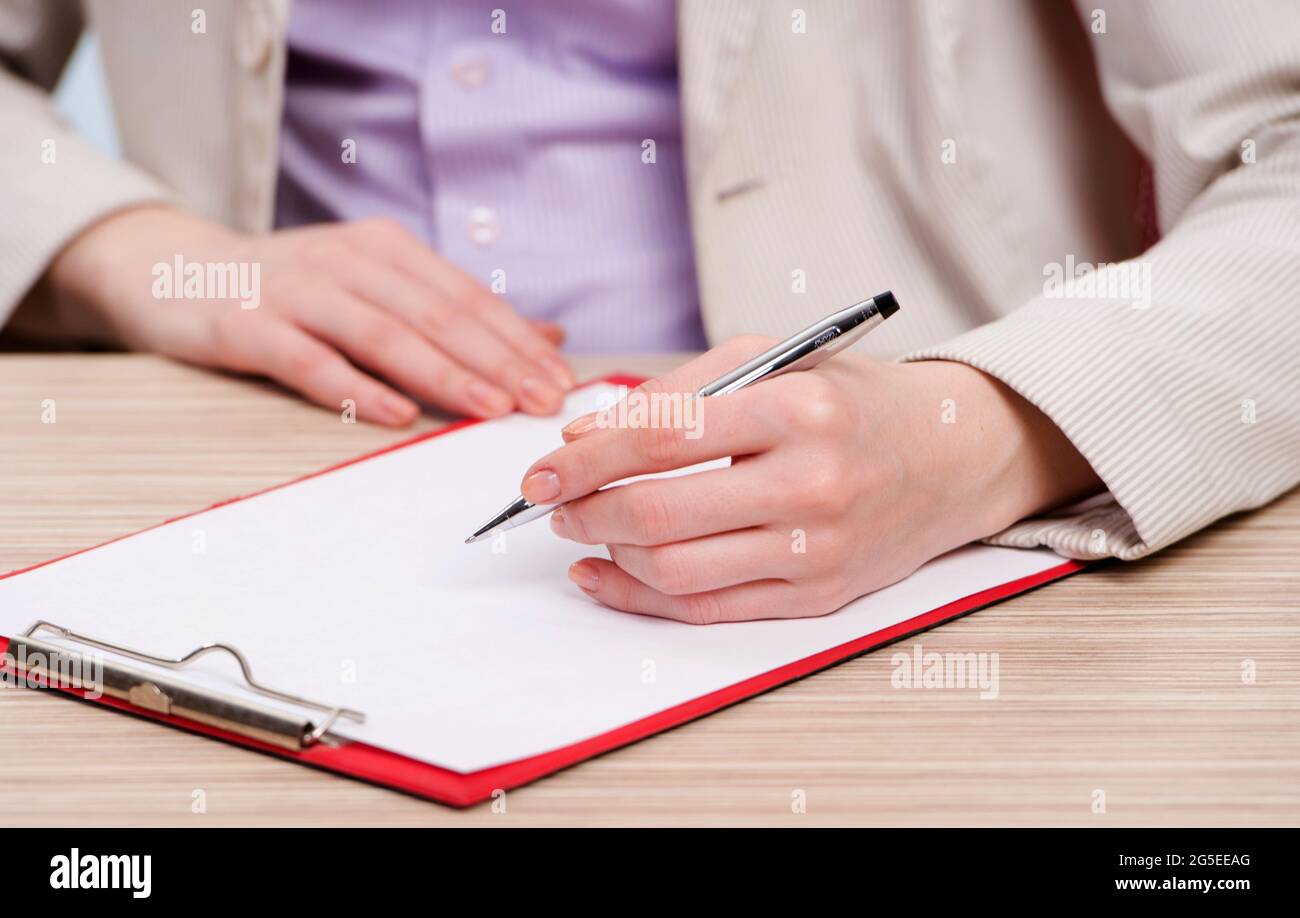 The hands taking notes in the pad Stock Photo - Alamy