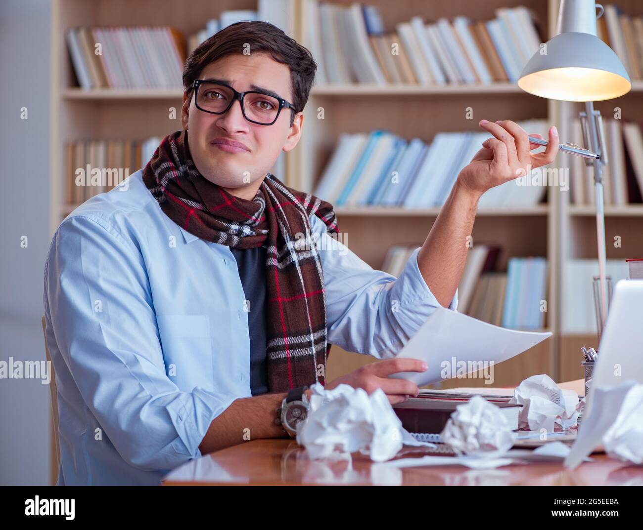 The young book writer writing in library Stock Photo - Alamy