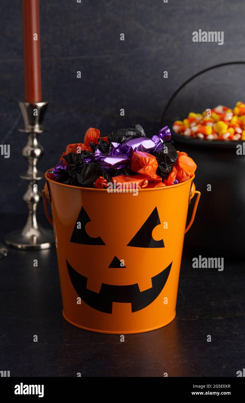 Pumpkin Bucket Filled with Various Wrapped Candies Stock Photo - Alamy