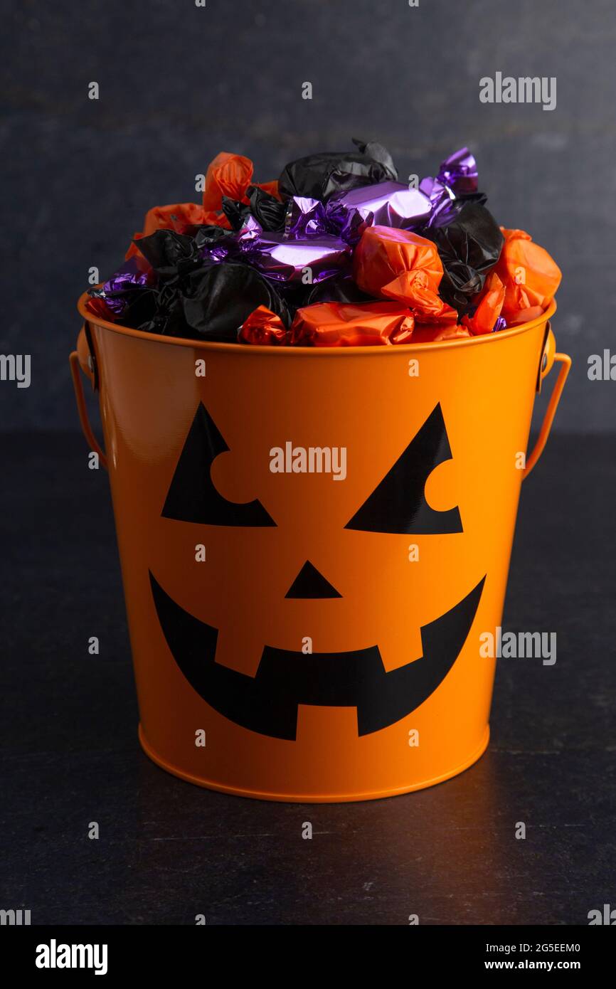 Pumpkin Bucket Filled with Various Wrapped Candies Stock Photo - Alamy