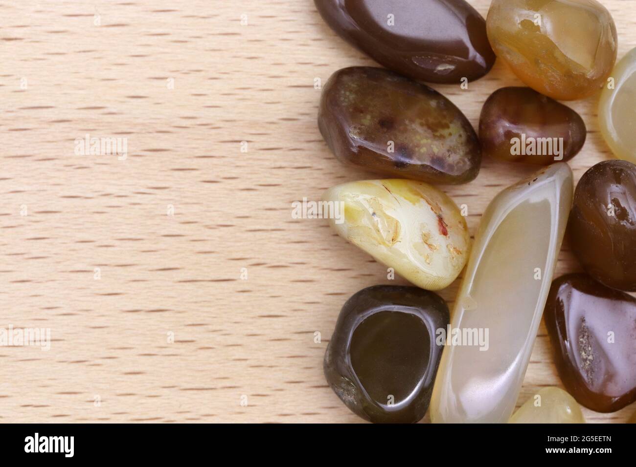 Yellow Agate heap jewel texture on half light varnished wood background ...