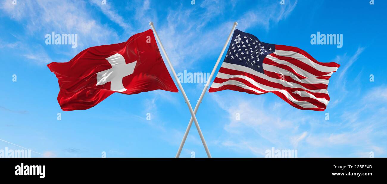 flags of USA and switzerland waving in the wind on flagpoles against ...