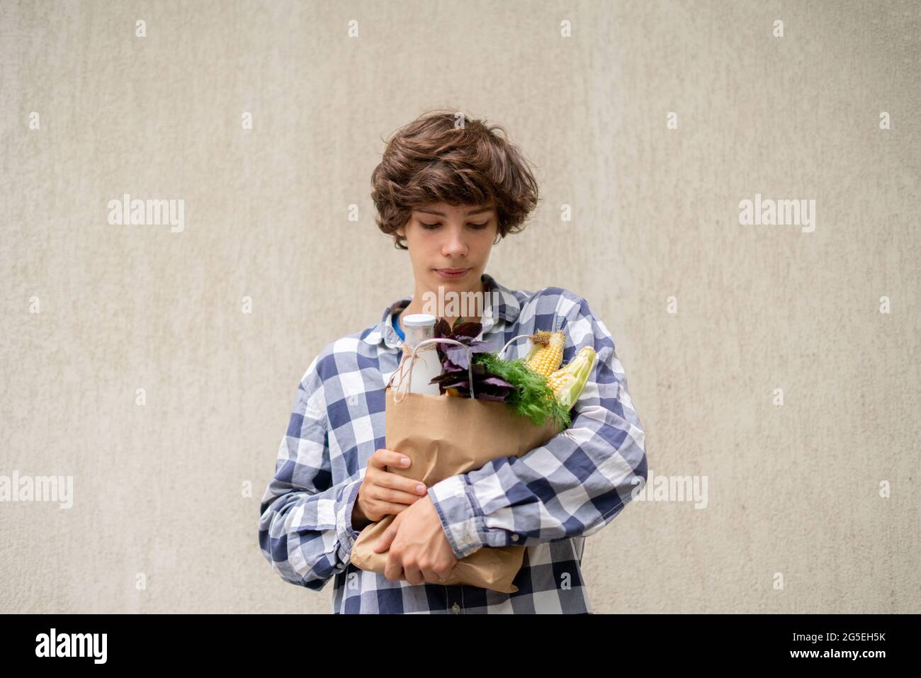 young man going home from the grocery store with fresh fruit and ...