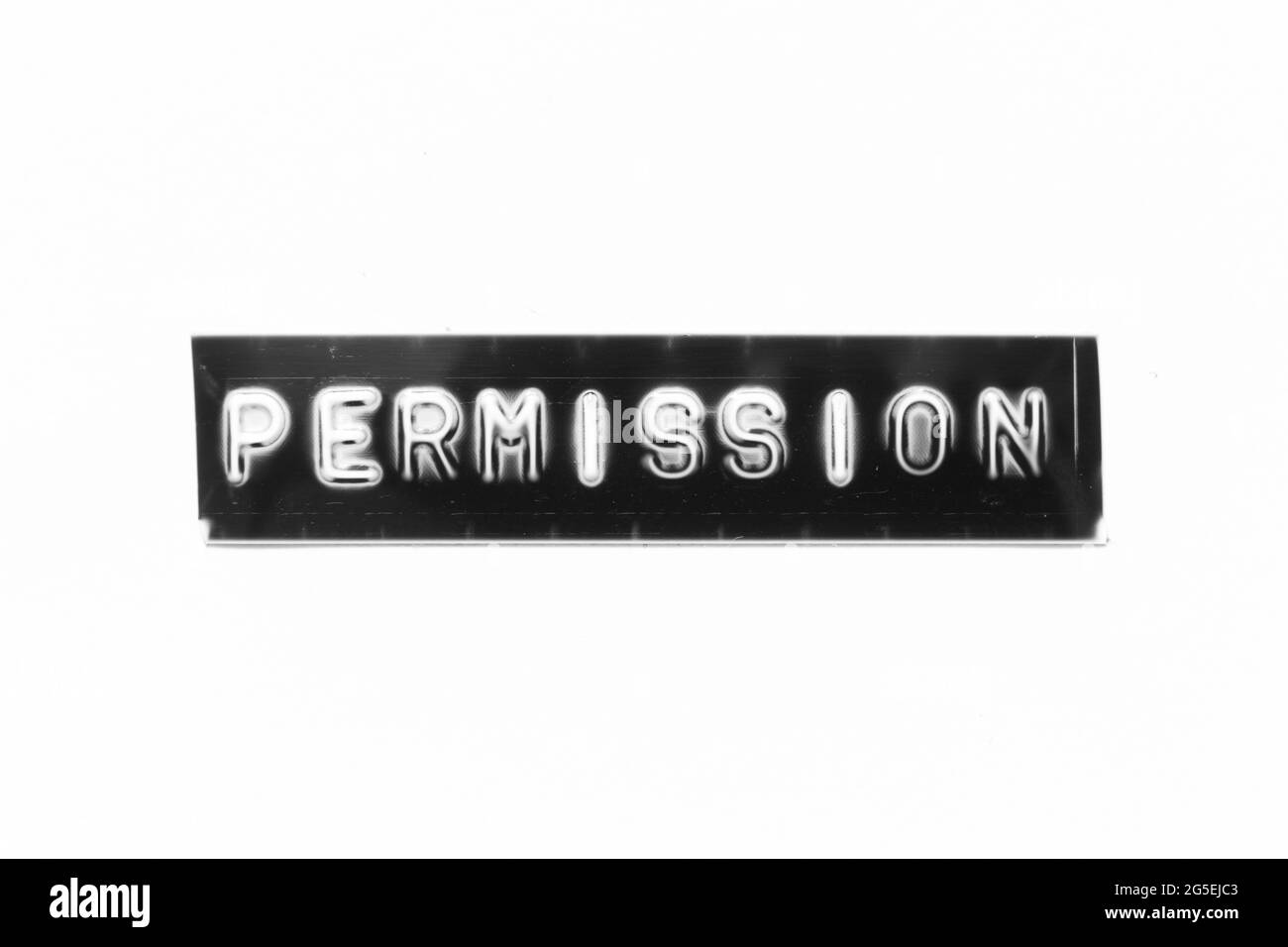 Embossed letter with word permission in black banner on white paper ...
