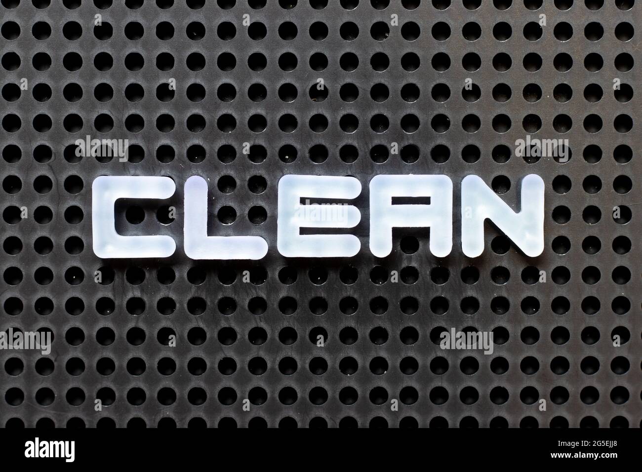 White color alphabet with word clean on black pegboard background Stock ...
