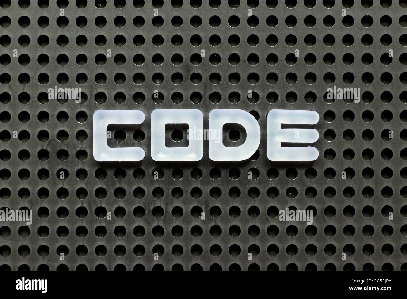 White color letter in word code on black pegboard background Stock ...