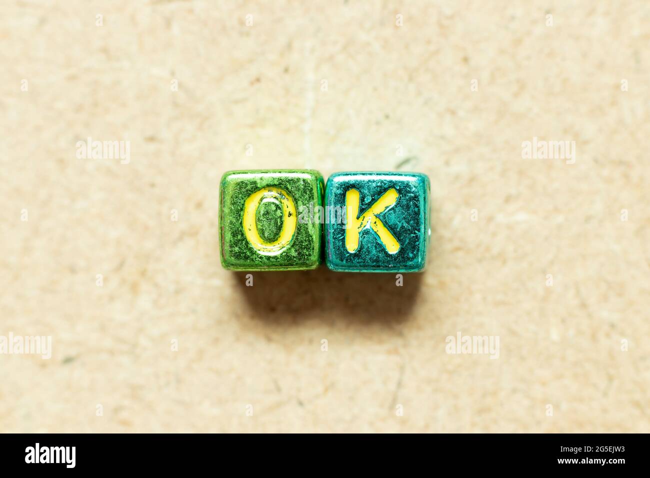 Metallic color alphabet letter block in word ok on wood background ...