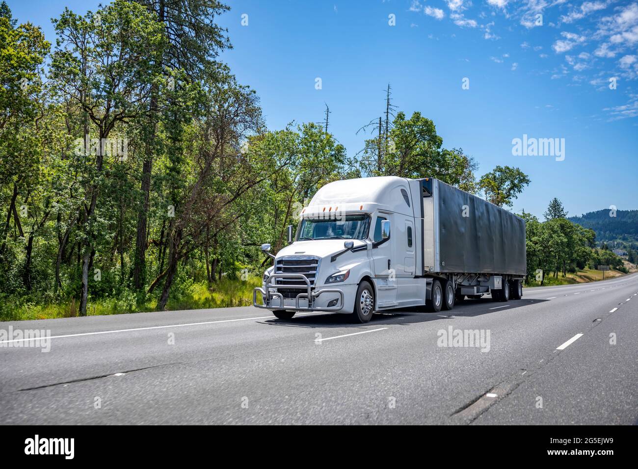 White big rig long haul day cab semi truck transporting commercial ...