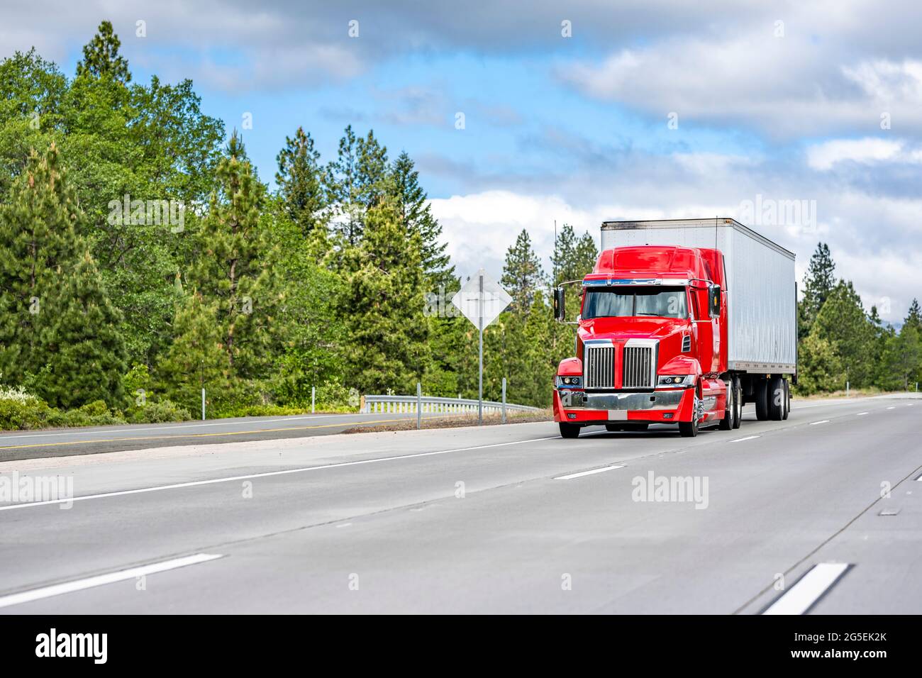 Red big rig long haul industrial semi truck tractor transporting ...
