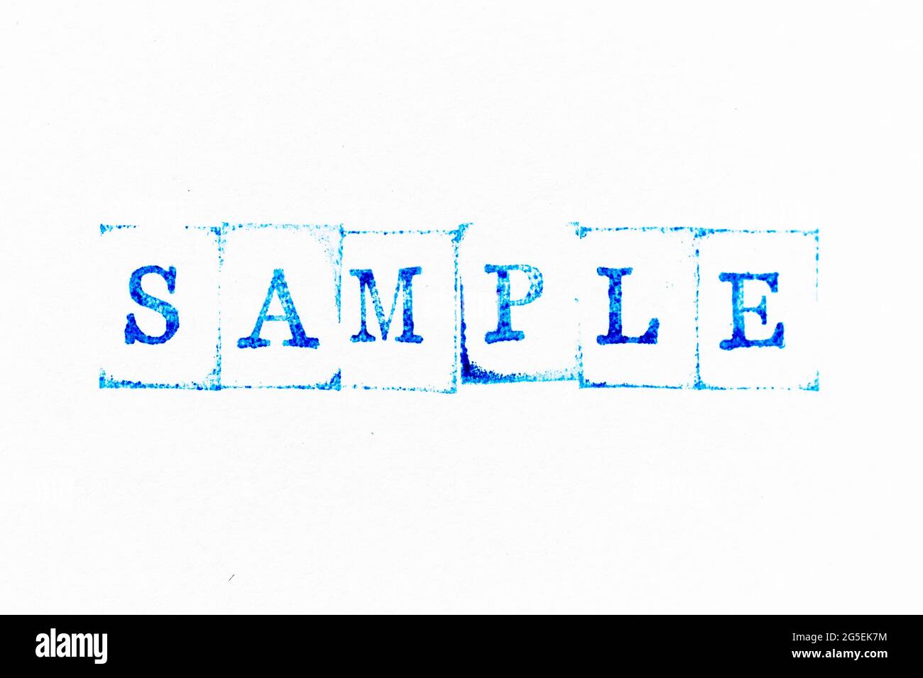 Blue color ink rubber stamp in word sample on white paper background ...