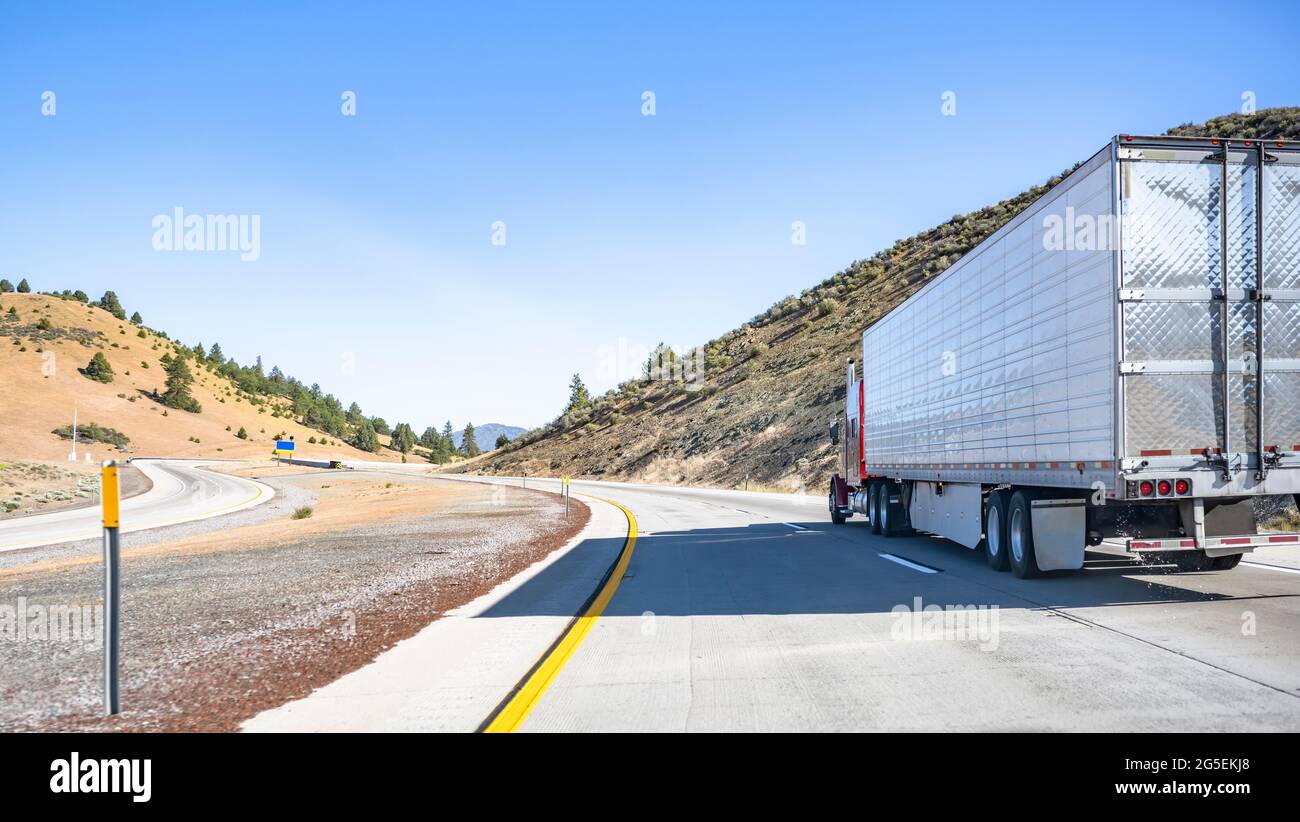 Classic bright red big rig semi truck with vertical chrome pipes ...