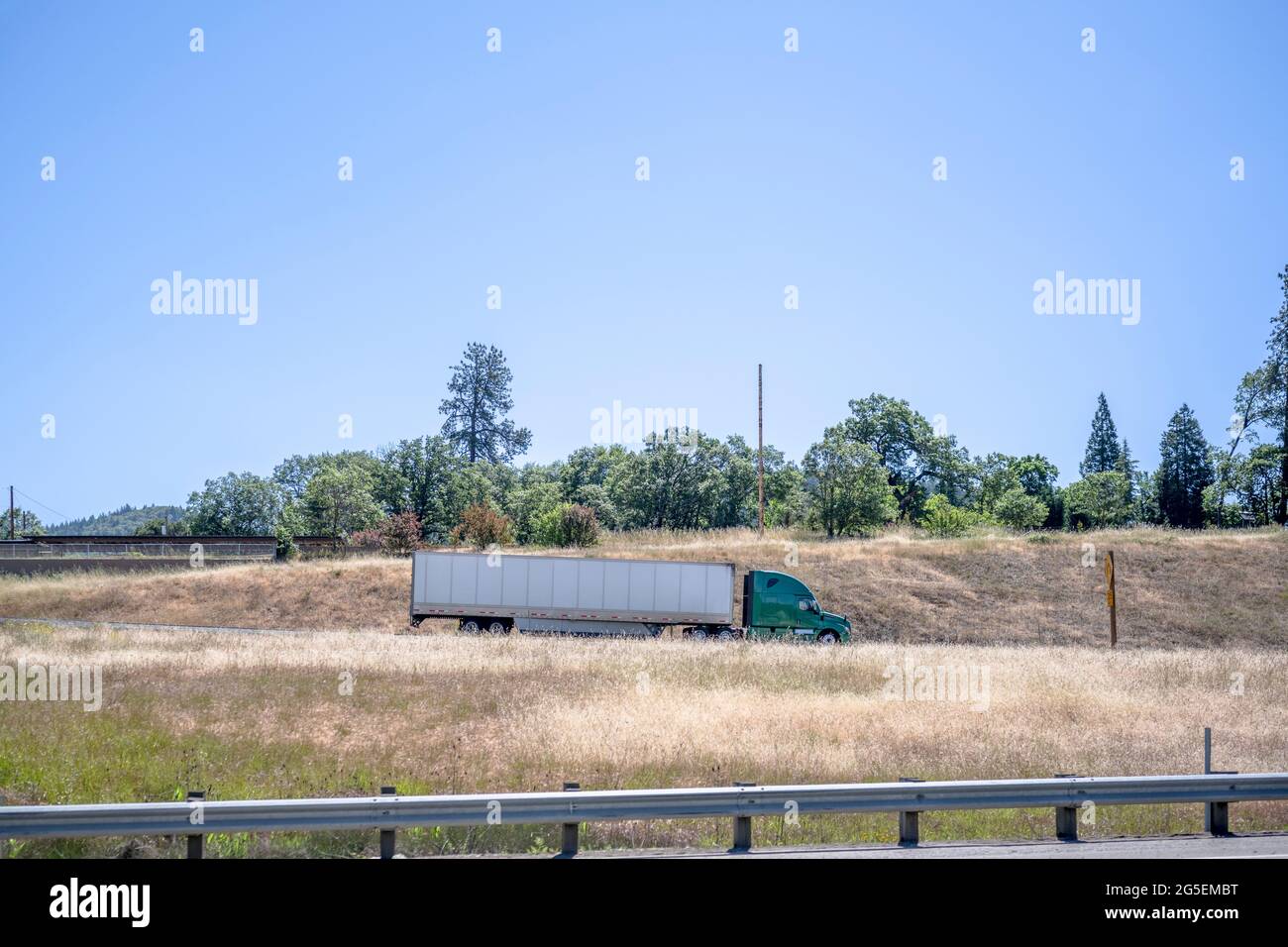 Green big rig long haul industrial semi truck tractor transporting ...