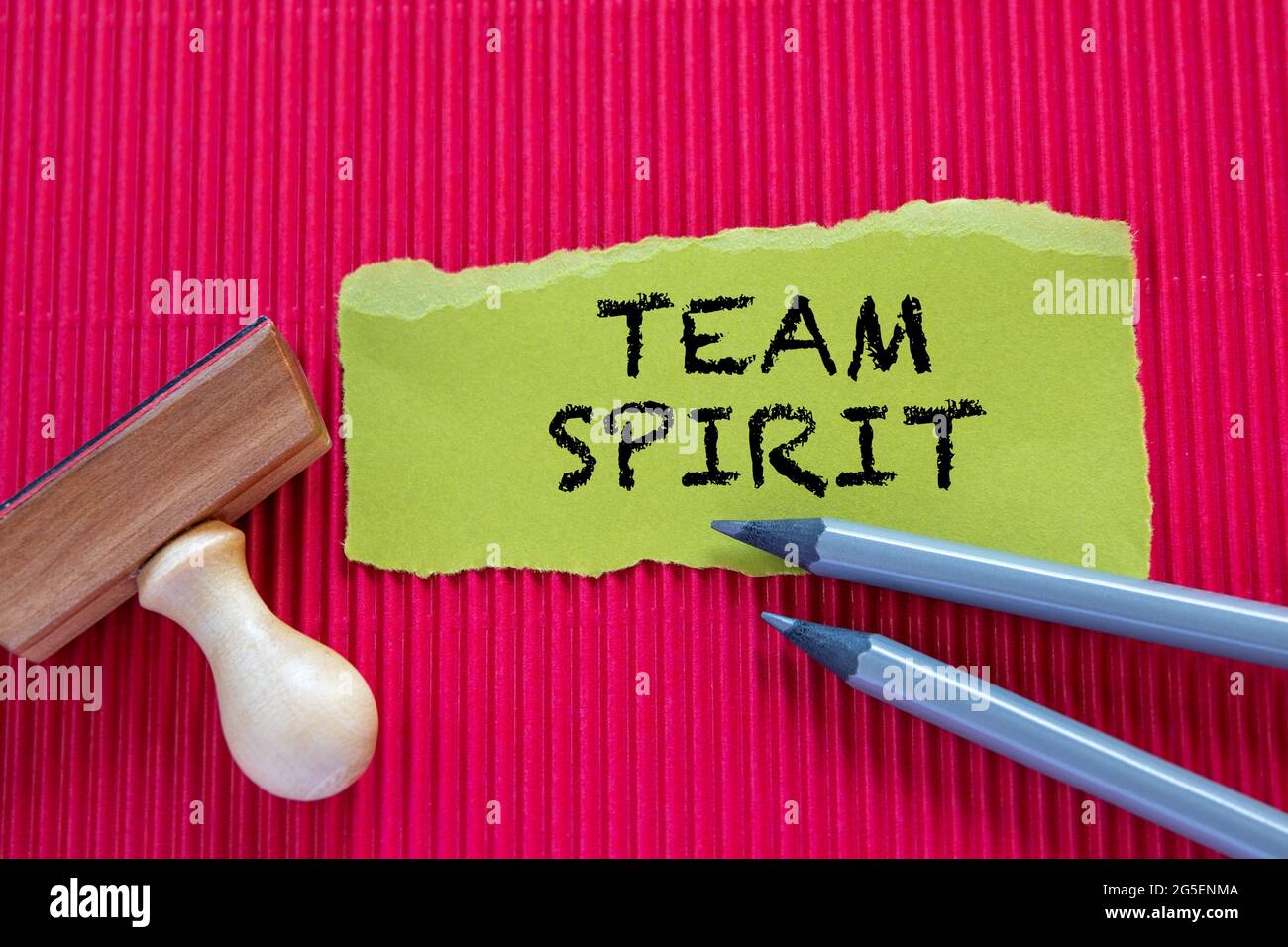 TEAM SPIRIT. Stamp and pencils on a red background Stock Photo - Alamy