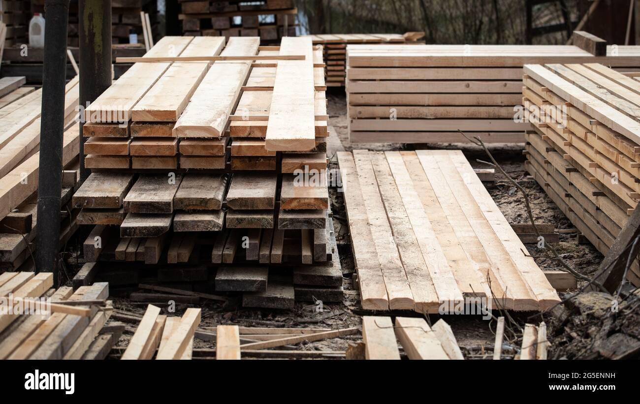 Sawn and stacked timber. Outdoor warehouse and production Stock Photo ...