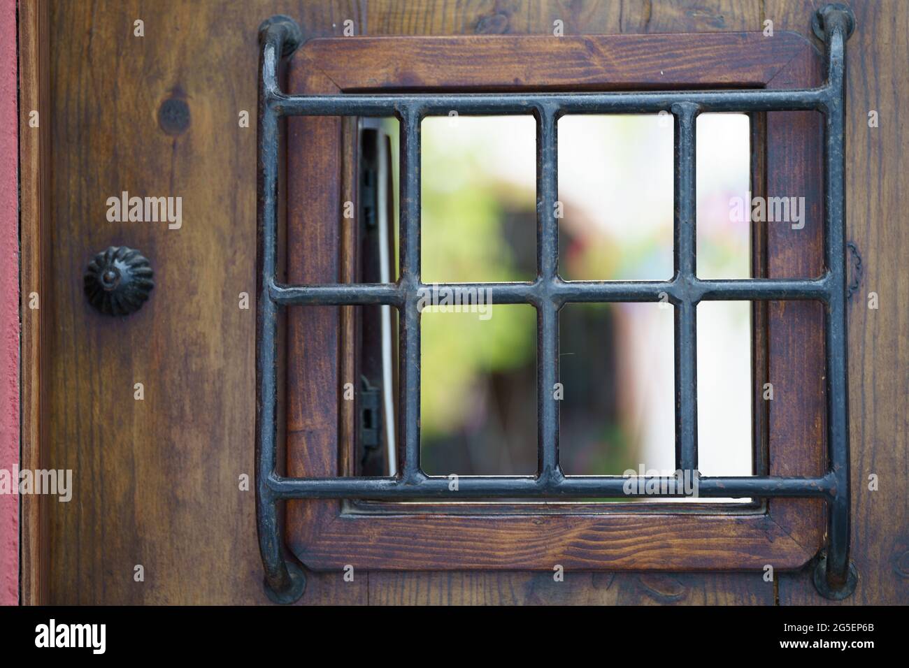 A wooden door with a small window for viewing Stock Photo - Alamy