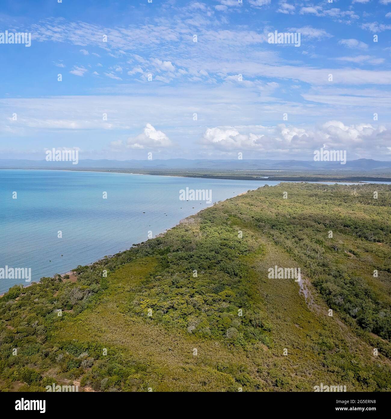 Aerial over a coastal shoreline with beaches and an island on the ...