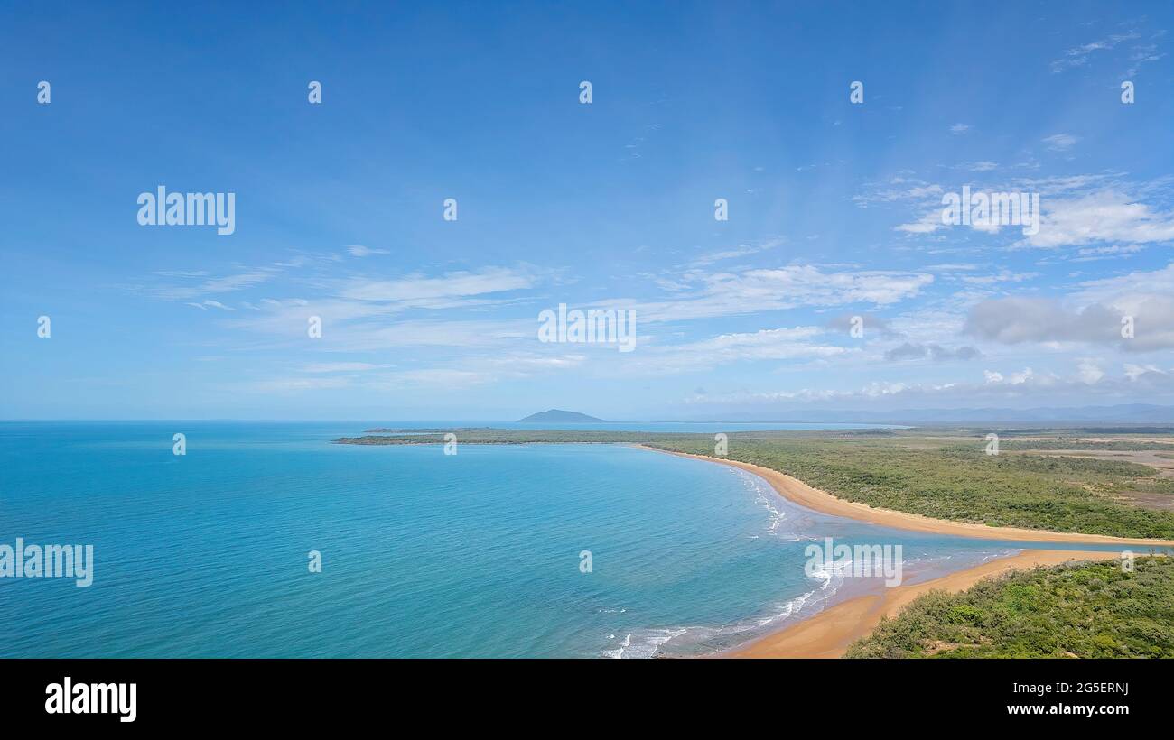 Aerial over a coastal shoreline with beaches and an island on the ...