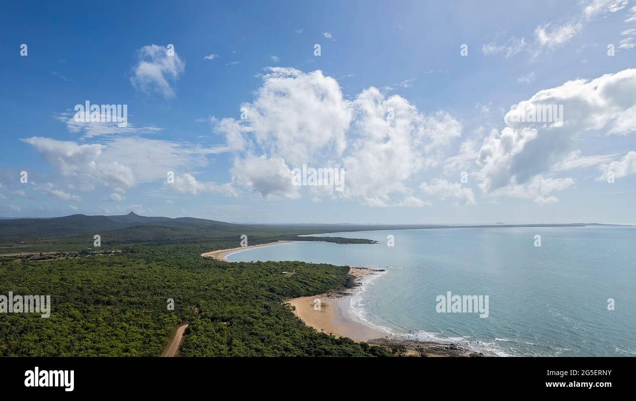 Aerial over a coastal shoreline with beaches and an island on the ...