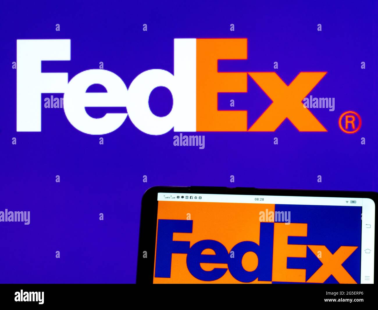 In this photo illustration a FedEx Corporation logo seen displayed on a ...