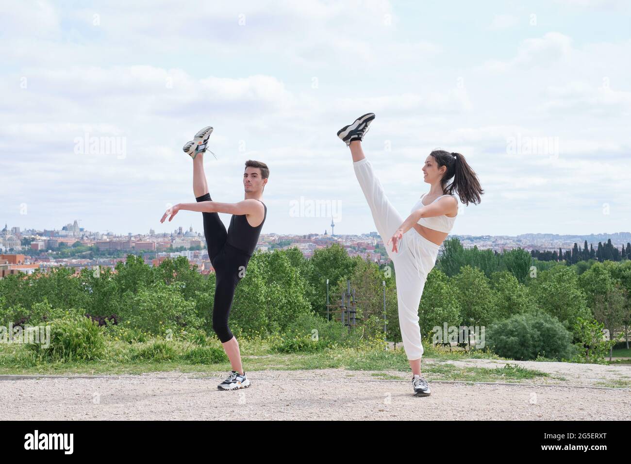 Young couple doing a high kick. Practicing street dance, ballet ...