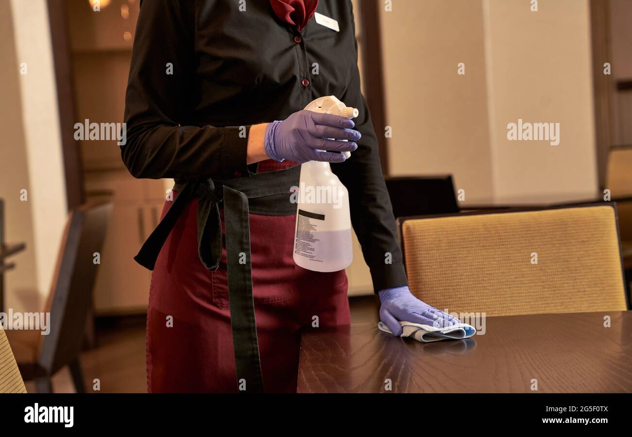 Person with cleaning detergent washing a table Stock Photo - Alamy