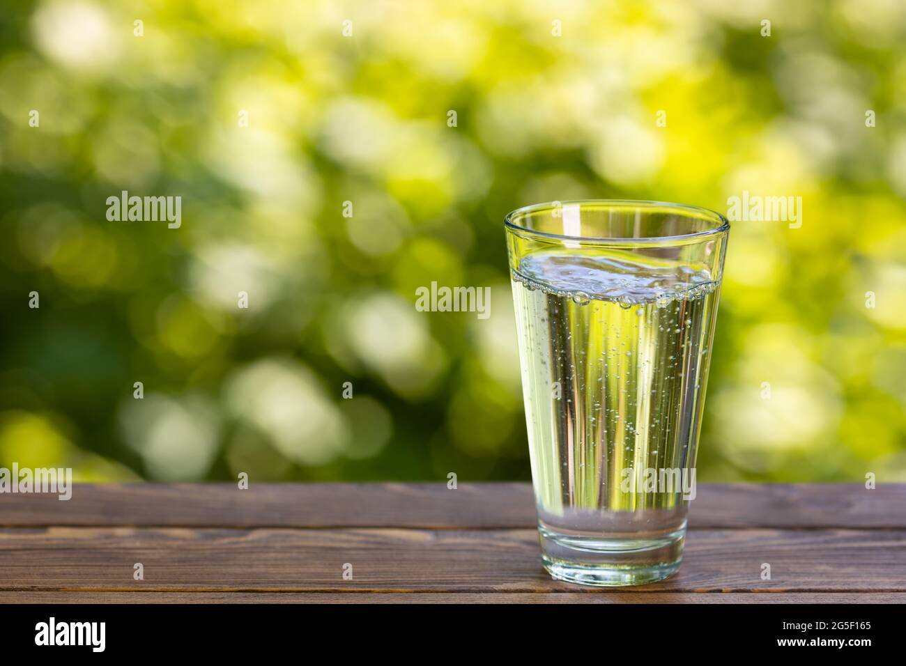glass of clean mineral water on table outdoors Stock Photo - Alamy
