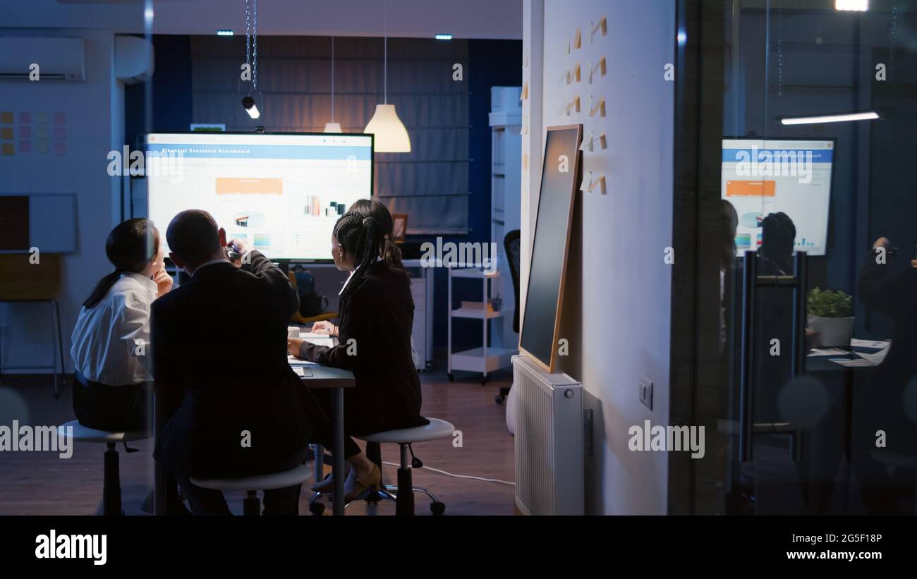 Focused businessman presenting company solution using presentation ...