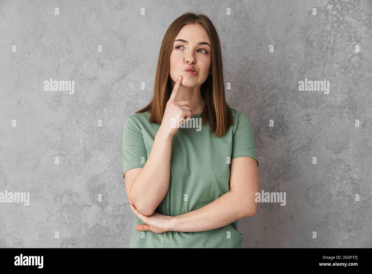 Brooding beautiful nice girl thinking and looking upward isolated over ...