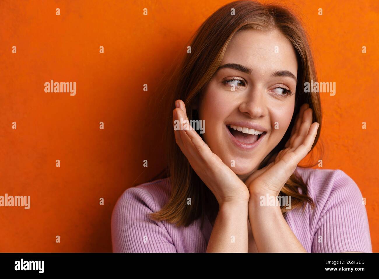 Young ginger happy woman gesturing and smiling at camera isolated over ...