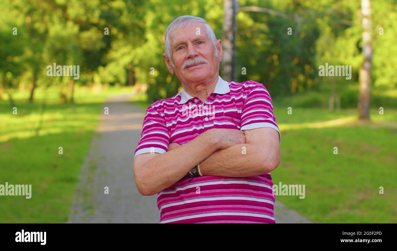 Happy lovely senior old gray-haired grandfather in casual red t-shirt ...