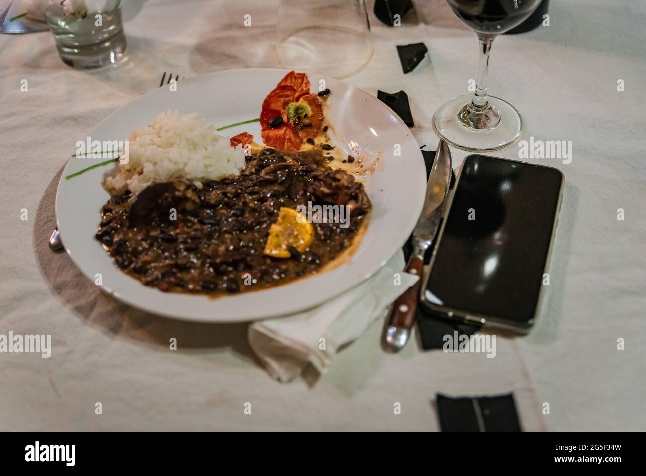 Typical Brazilian dish called Feijoada. Made with black beans, pork and ...