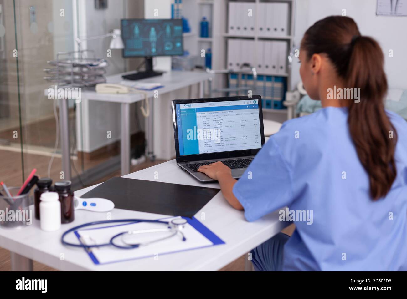 Doctor nurse looking computer monitor hi-res stock photography and ...