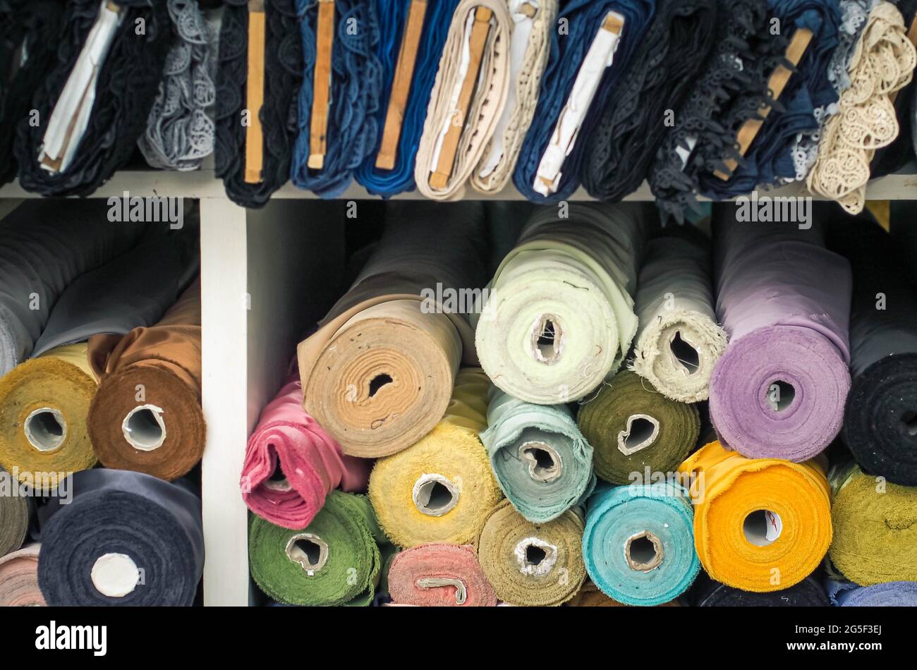 colorful fabric rolls in textile shop industry.Rolls of bright colored ...