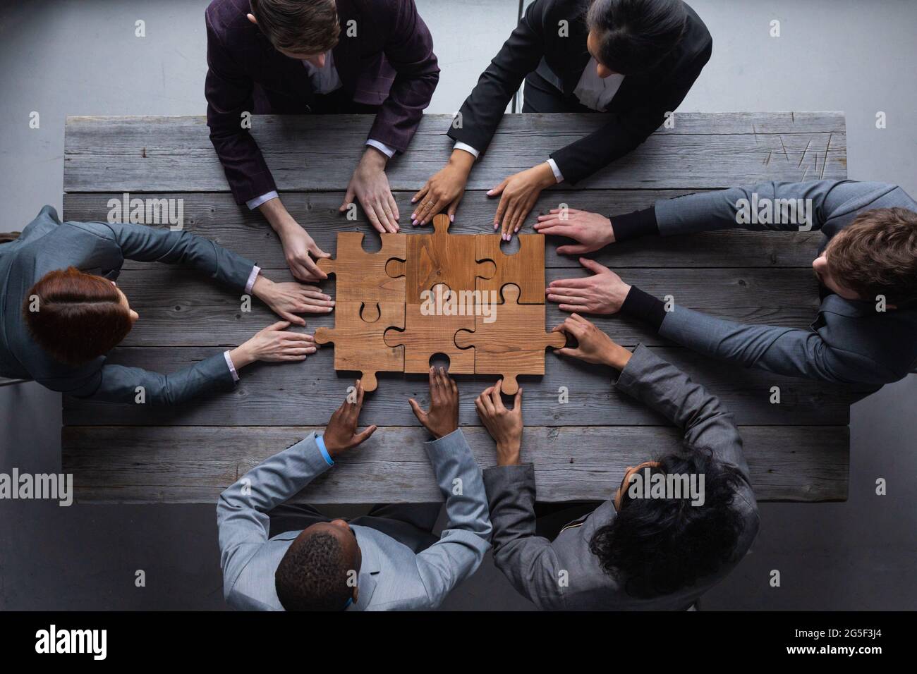 Business teamwork with puzzle finishing project cooperation unity ...