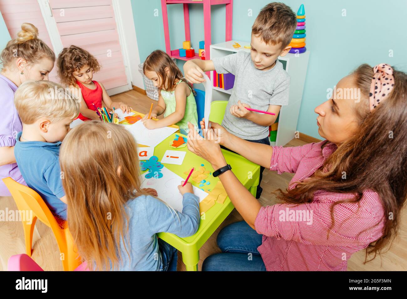 Preschool children learn english alphabet using cards Stock Photo - Alamy