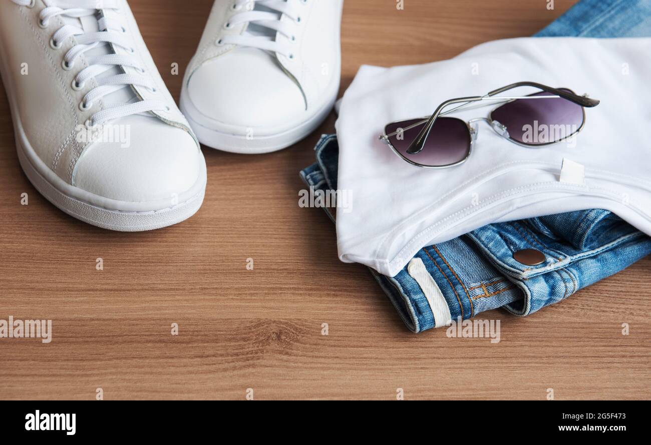 Stylish female clothes set. Woman outfit on wooden background. Online ...