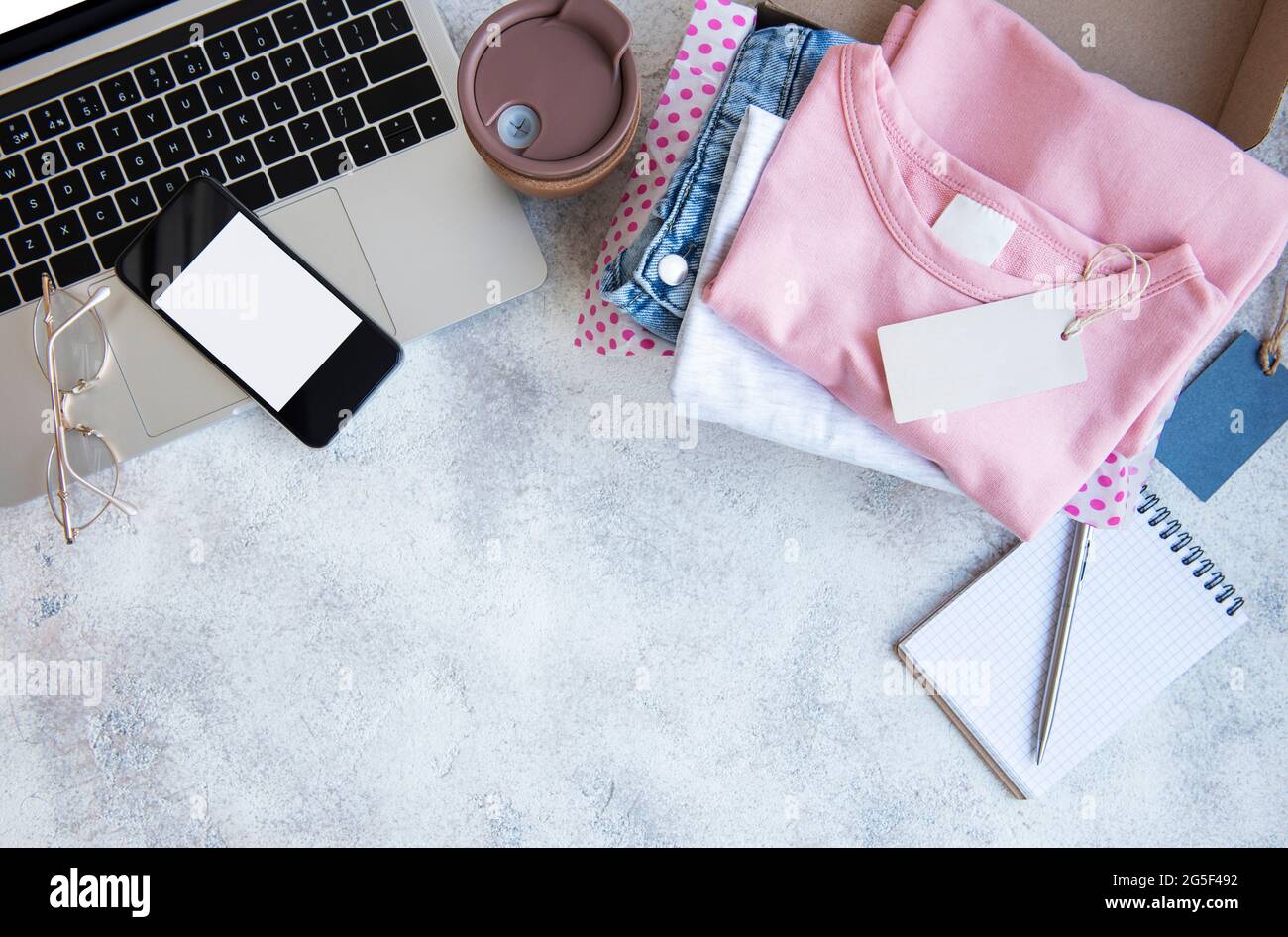 Online shopping concept. A laptop and a set of women's clothing in a ...