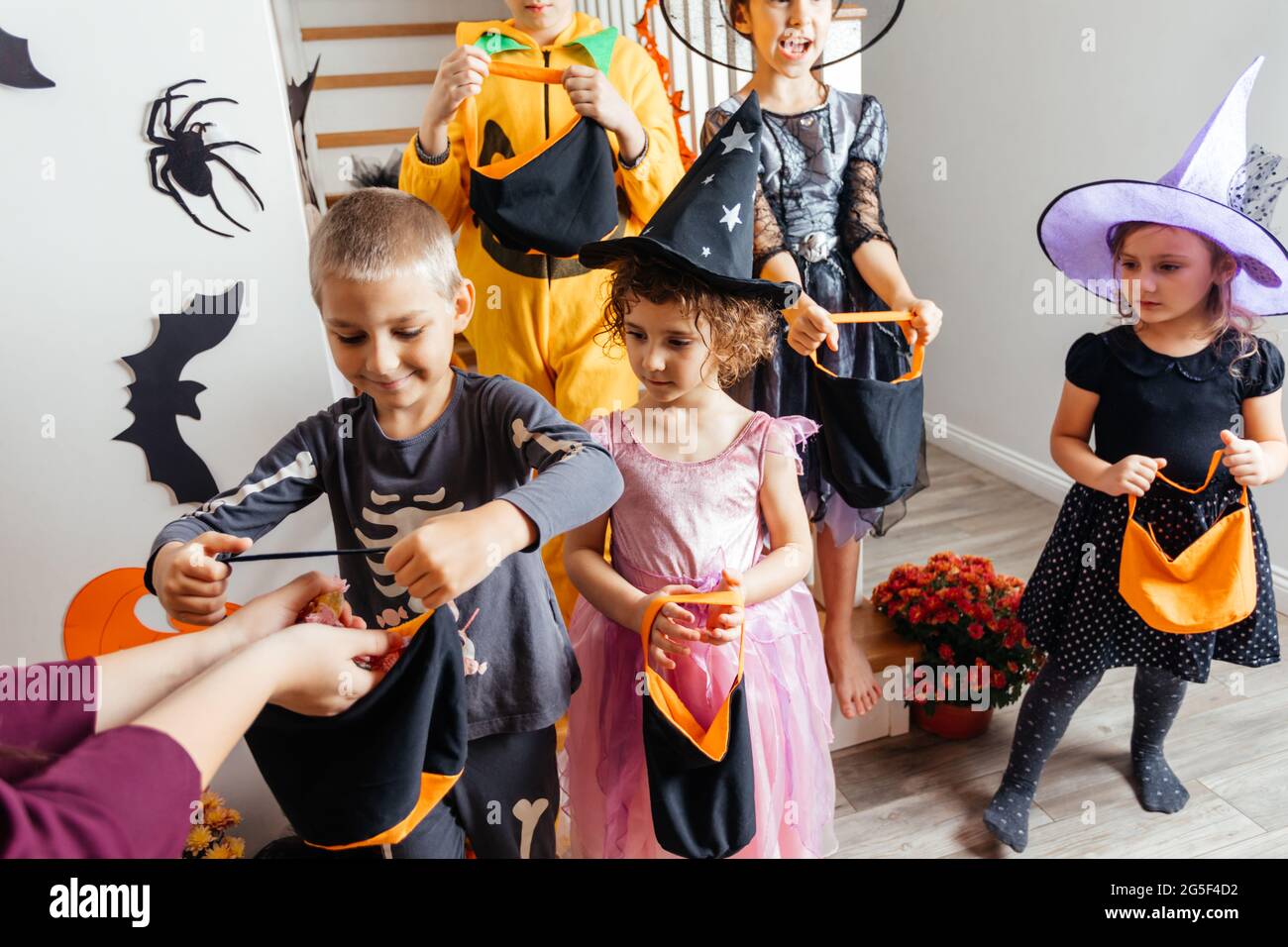 Group of kids waiting for Halloween candies Stock Photo - Alamy